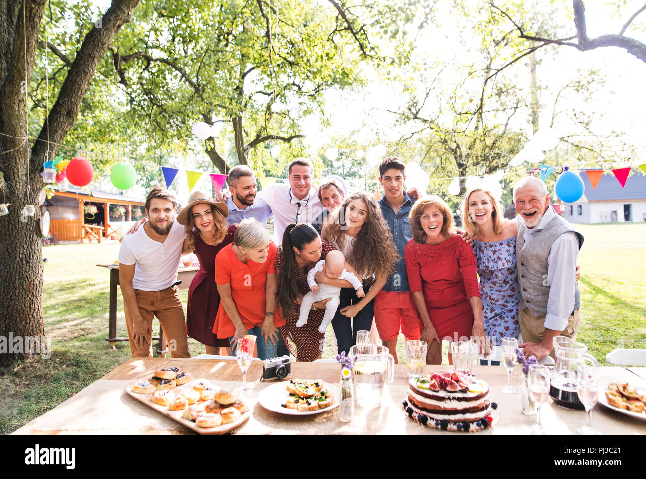 Family celebration outside in the backyard. Big garden party. Birthday ...