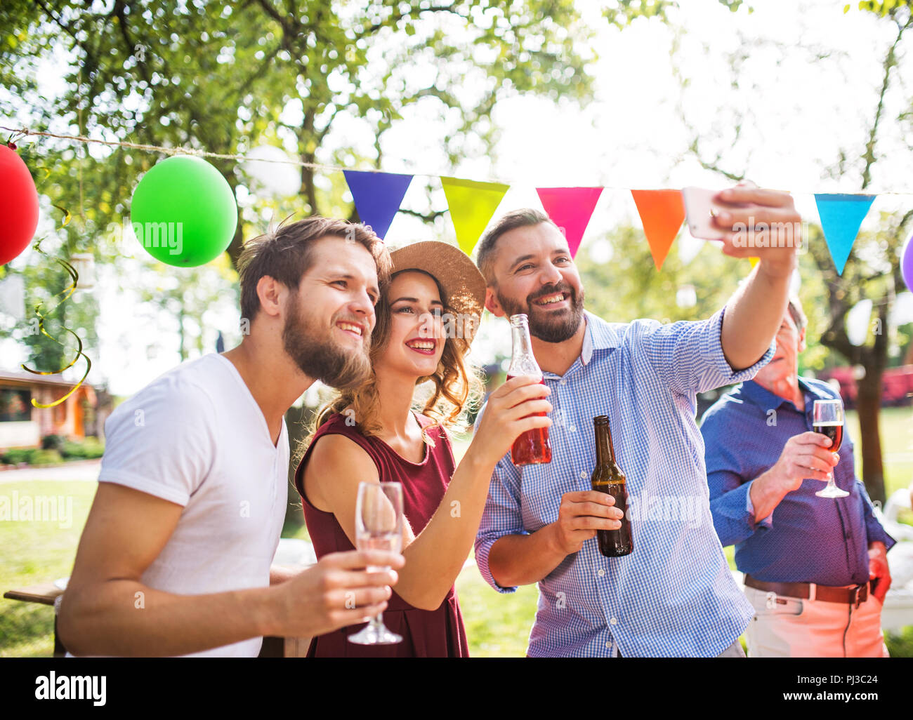 Young people taking selfie at a party outside in the backyard Stock ...