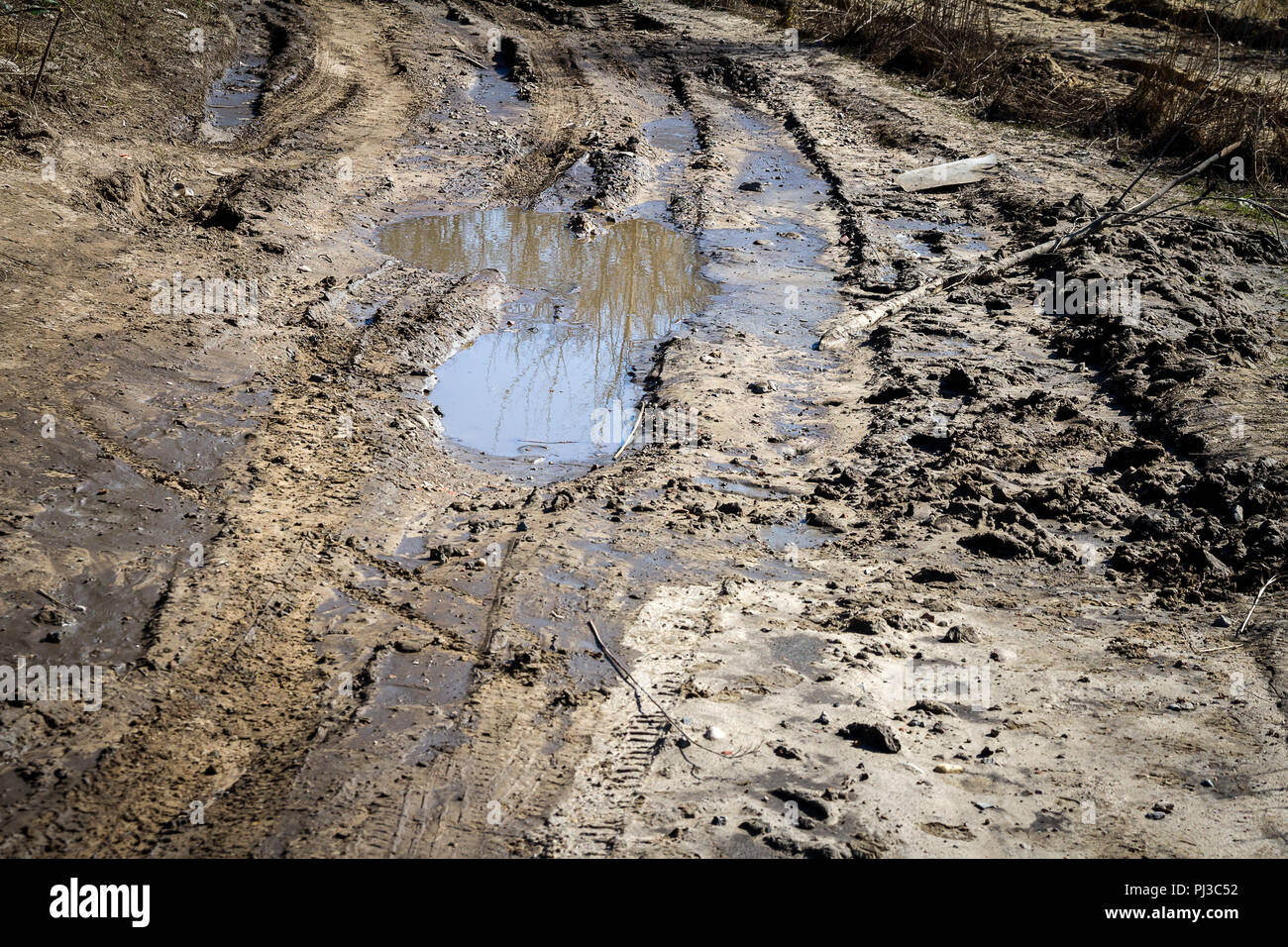 Deep car rut on a dirt road. Empty countryside dirt wet road Stock ...