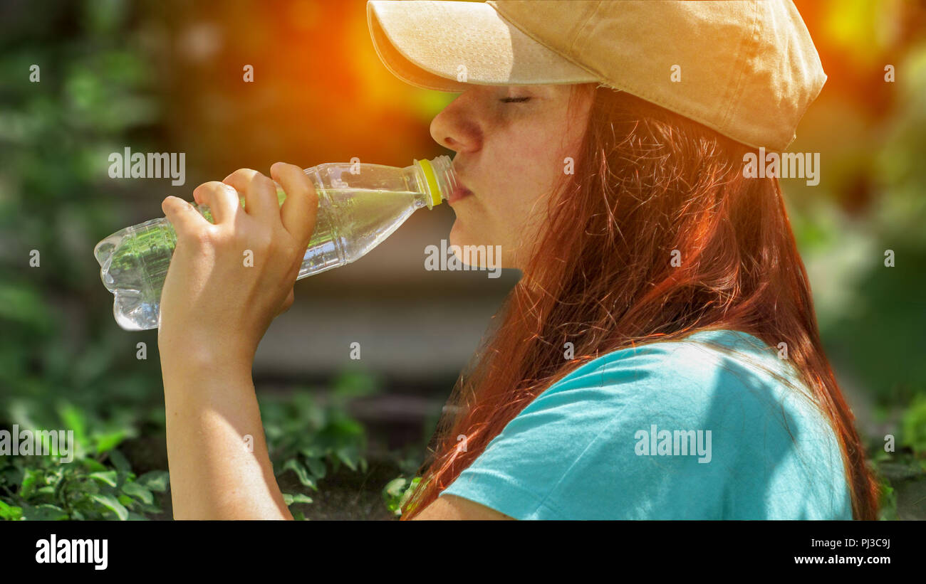 Woman drinking water in summer sunlight Stock Photo - Alamy