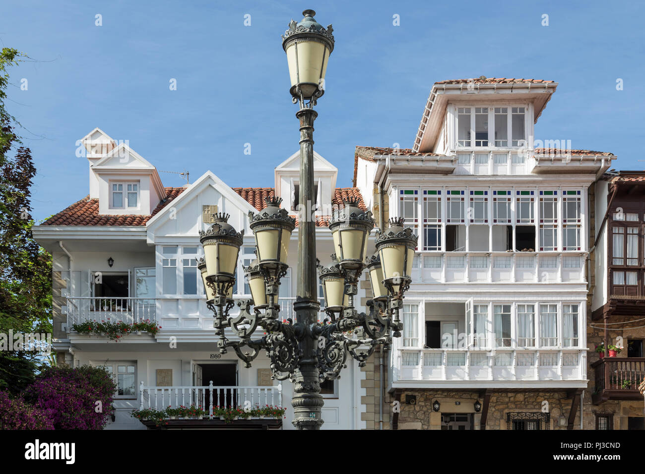 view of a classic lamppost on a street in Comillas, at the back facade ...