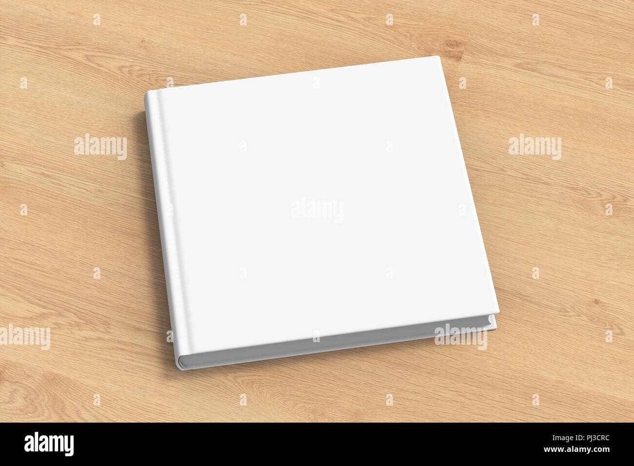 Square blank book cover mockup standing on wooden background with ...