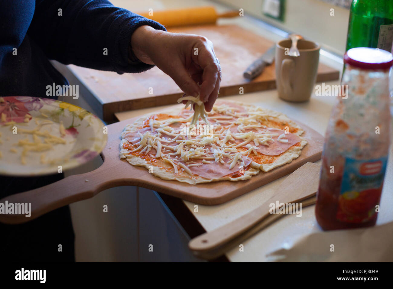 Adding cheese pizza hi-res stock photography and images - Alamy