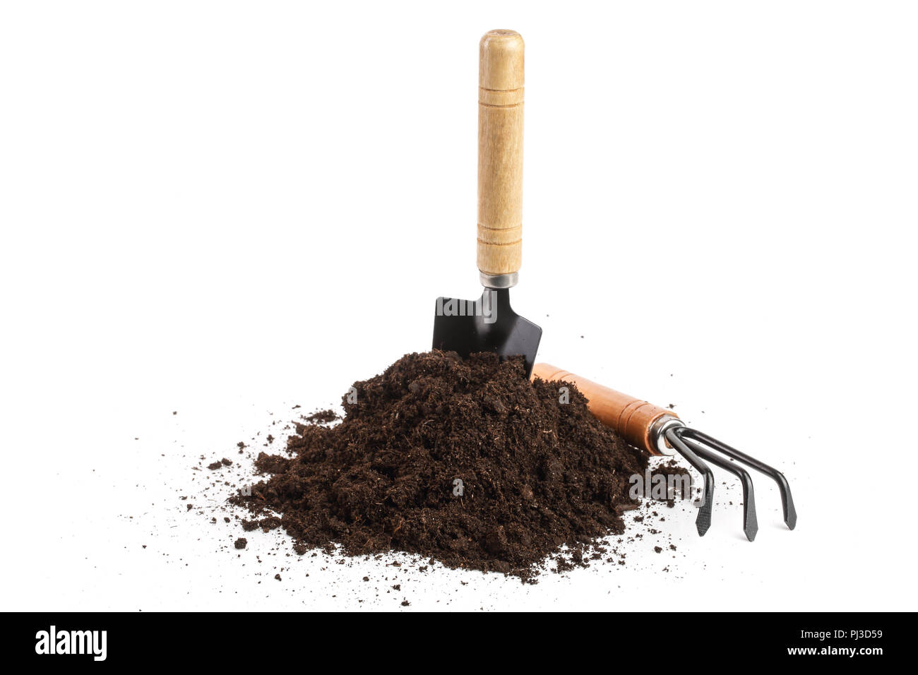 garden tools in soil isolated on white background Stock Photo - Alamy