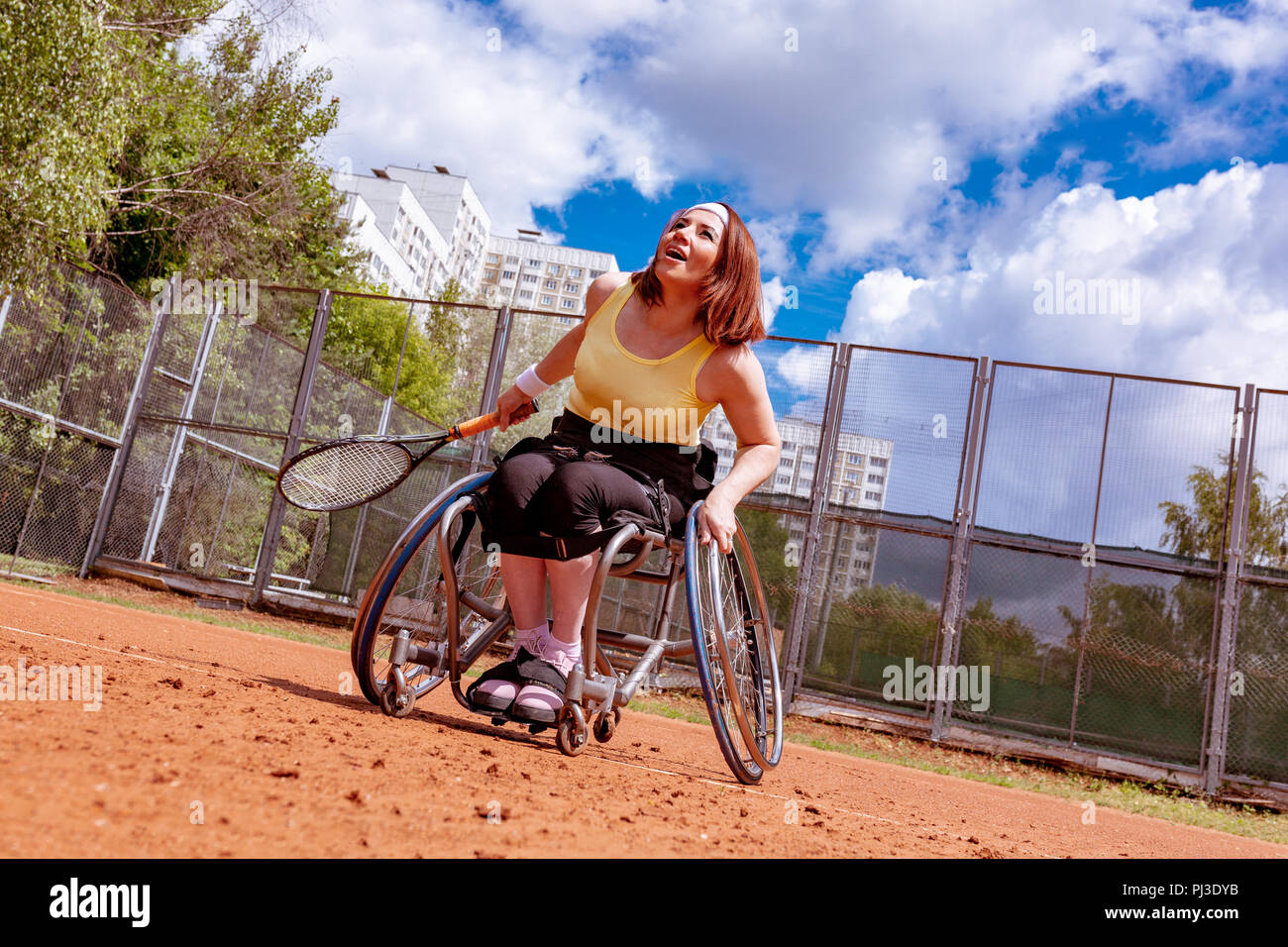 Disabled young woman on wheelchair playing tennis on tennis court Stock ...