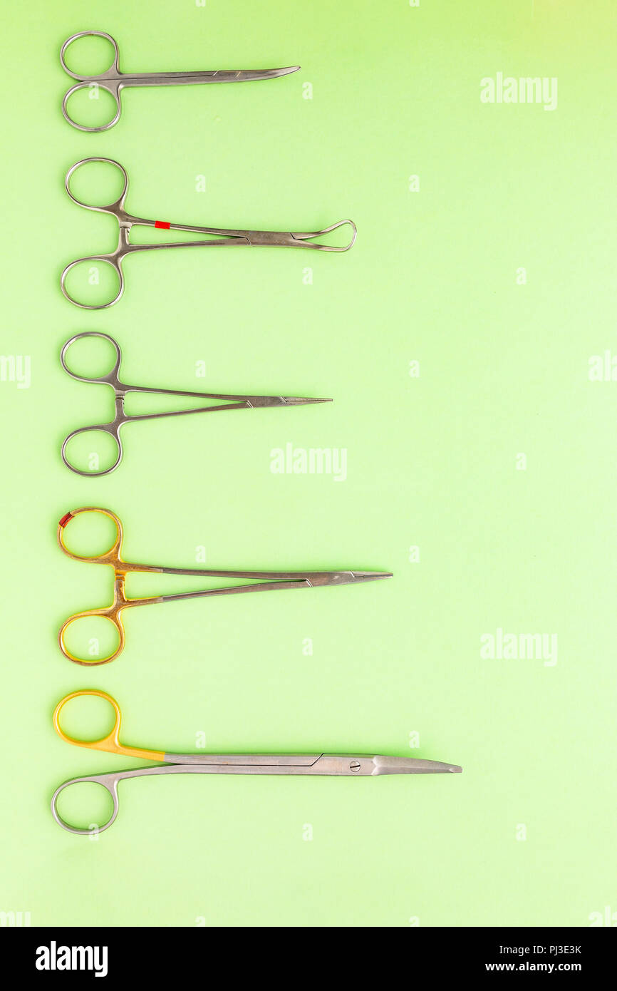 Medical equipments including surgical instruments on a green background ...