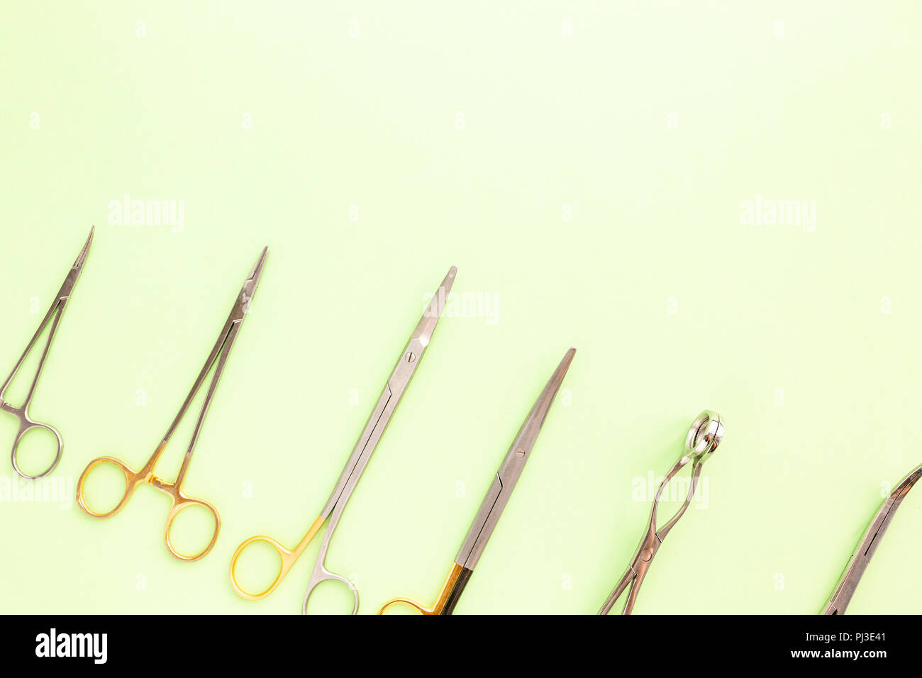 Medical equipments including surgical instruments on a green background ...