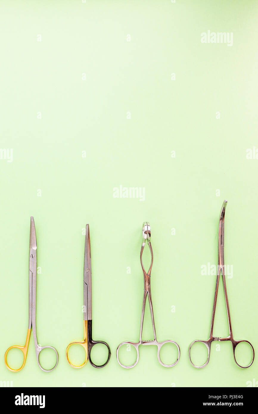 Medical equipments including surgical instruments on a green background ...