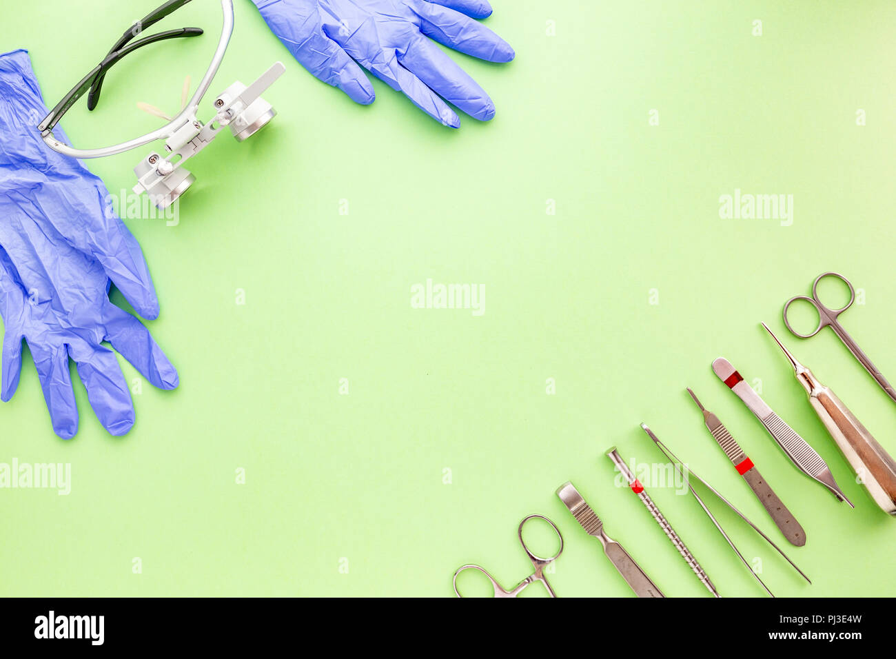Medical equipments including surgical instruments on a green background ...