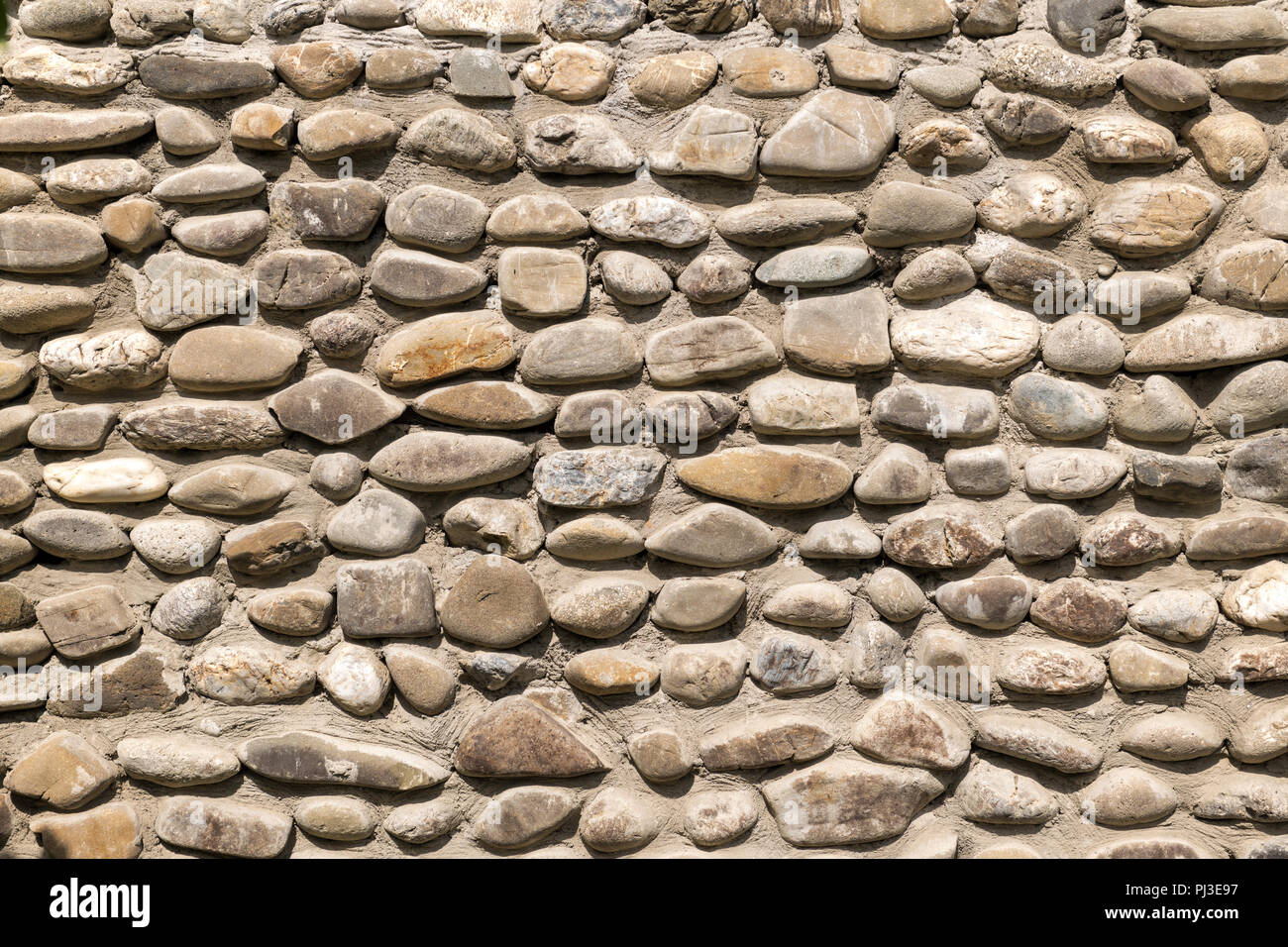 Old stone wall made with irregular blocks background texture with high ...