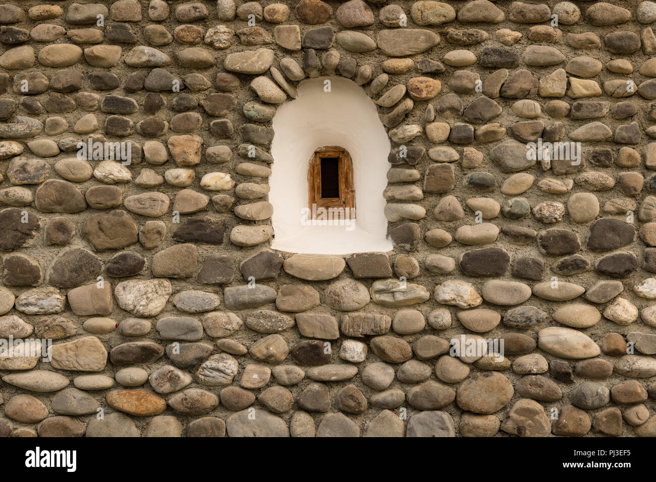 Old stone wall made with irregular blocks and window background texture ...