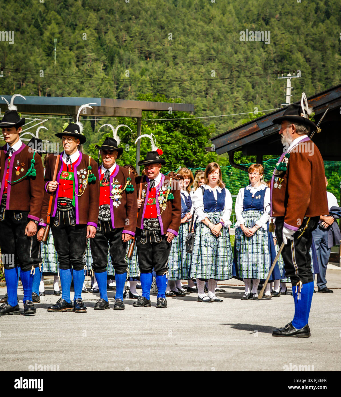 Tyrolean Militia men and maidens march out of the village square on ...