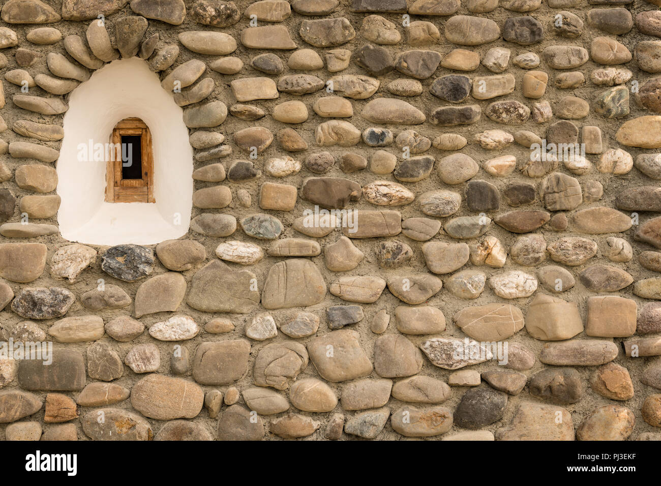 Old stone wall made with irregular blocks and window background texture ...