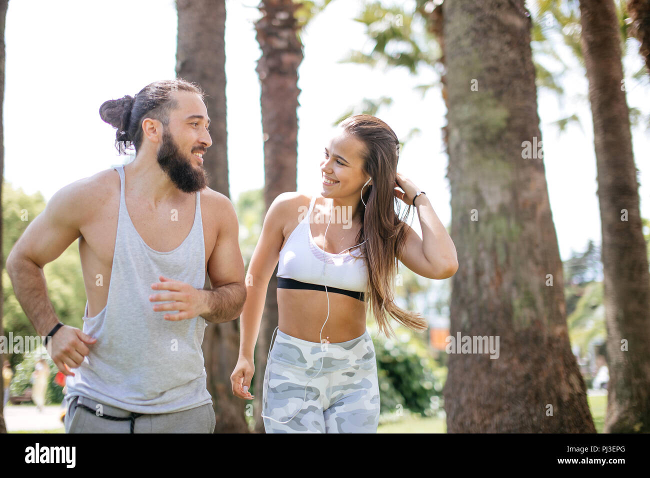 Athletic couple running together sunrise hi-res stock photography and ...