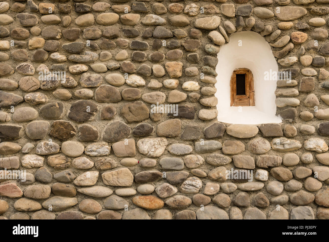 Old stone wall made with irregular blocks and window background texture ...