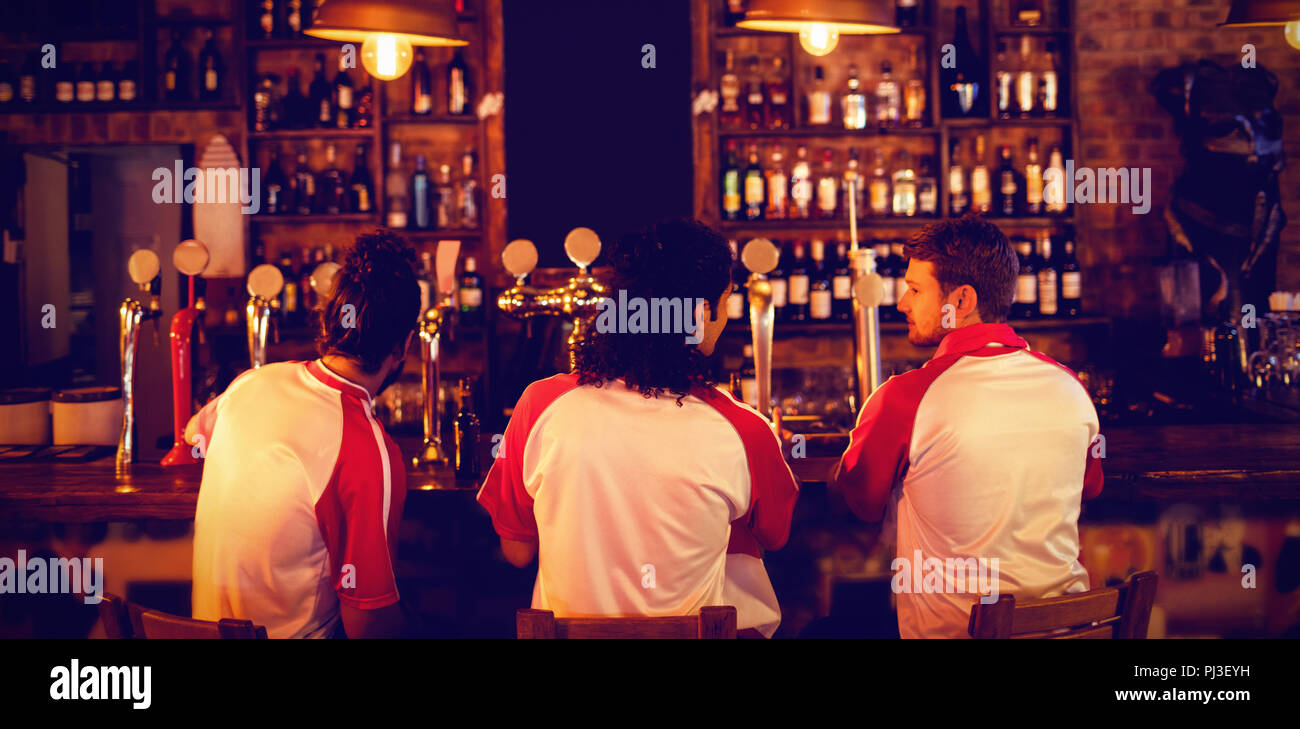 Group of male friends sitting at counter Stock Photo - Alamy