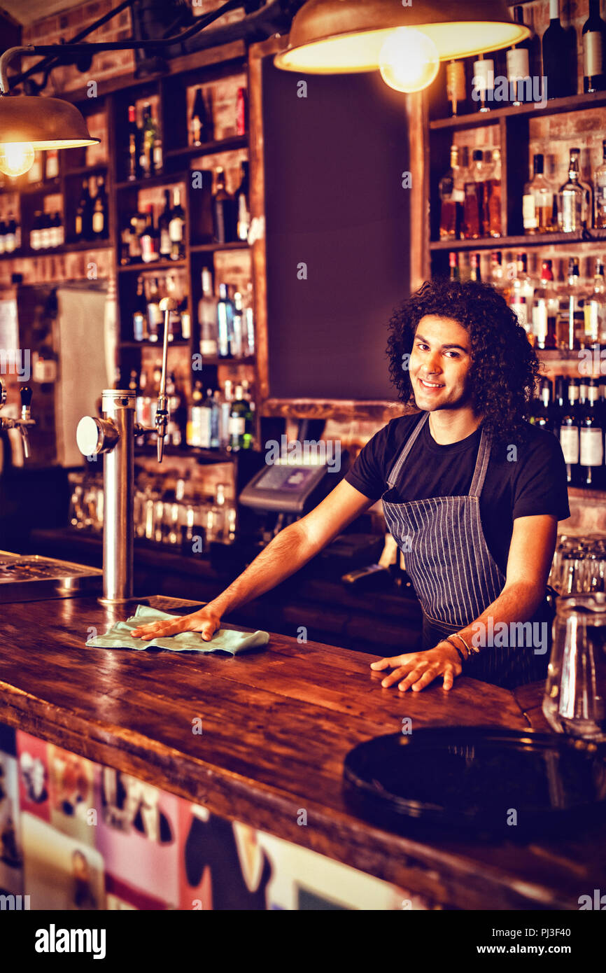 Portrait of young waiter cleaning a counter Stock Photo - Alamy