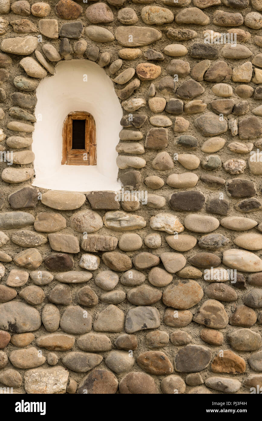 Old stone wall made with irregular blocks and window background texture ...