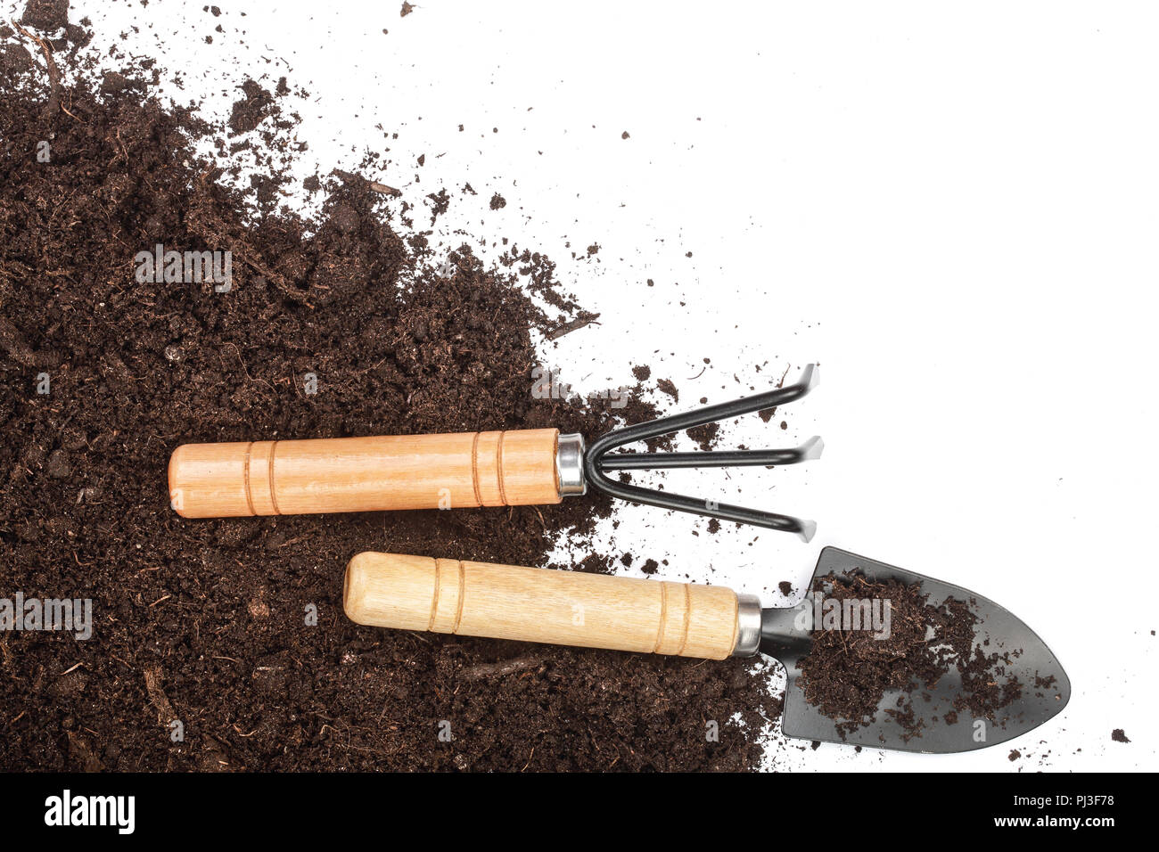 garden tools in soil isolated on white background with copy space for ...