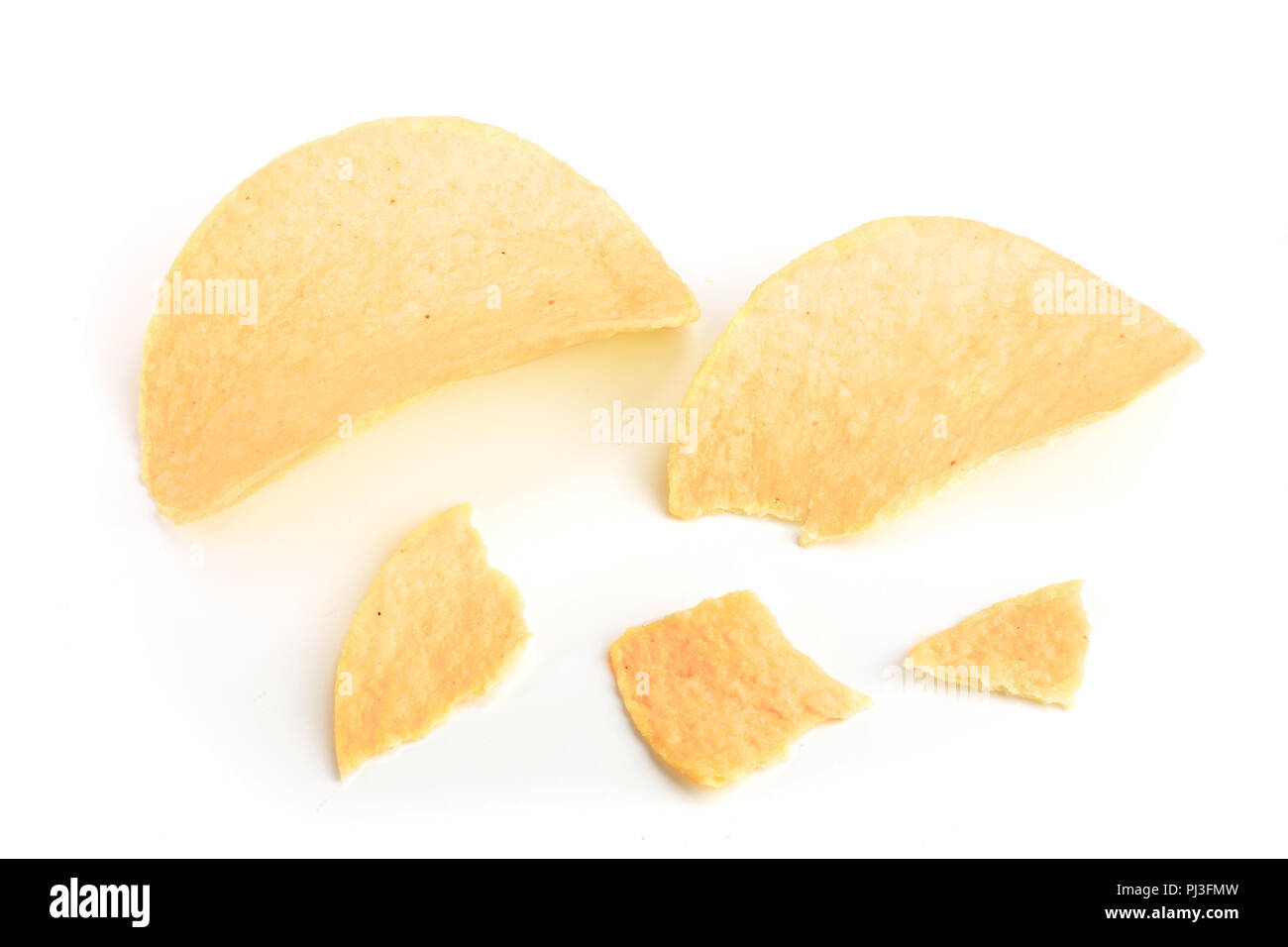Potato chips crumbs and leftovers isolated over the white background ...