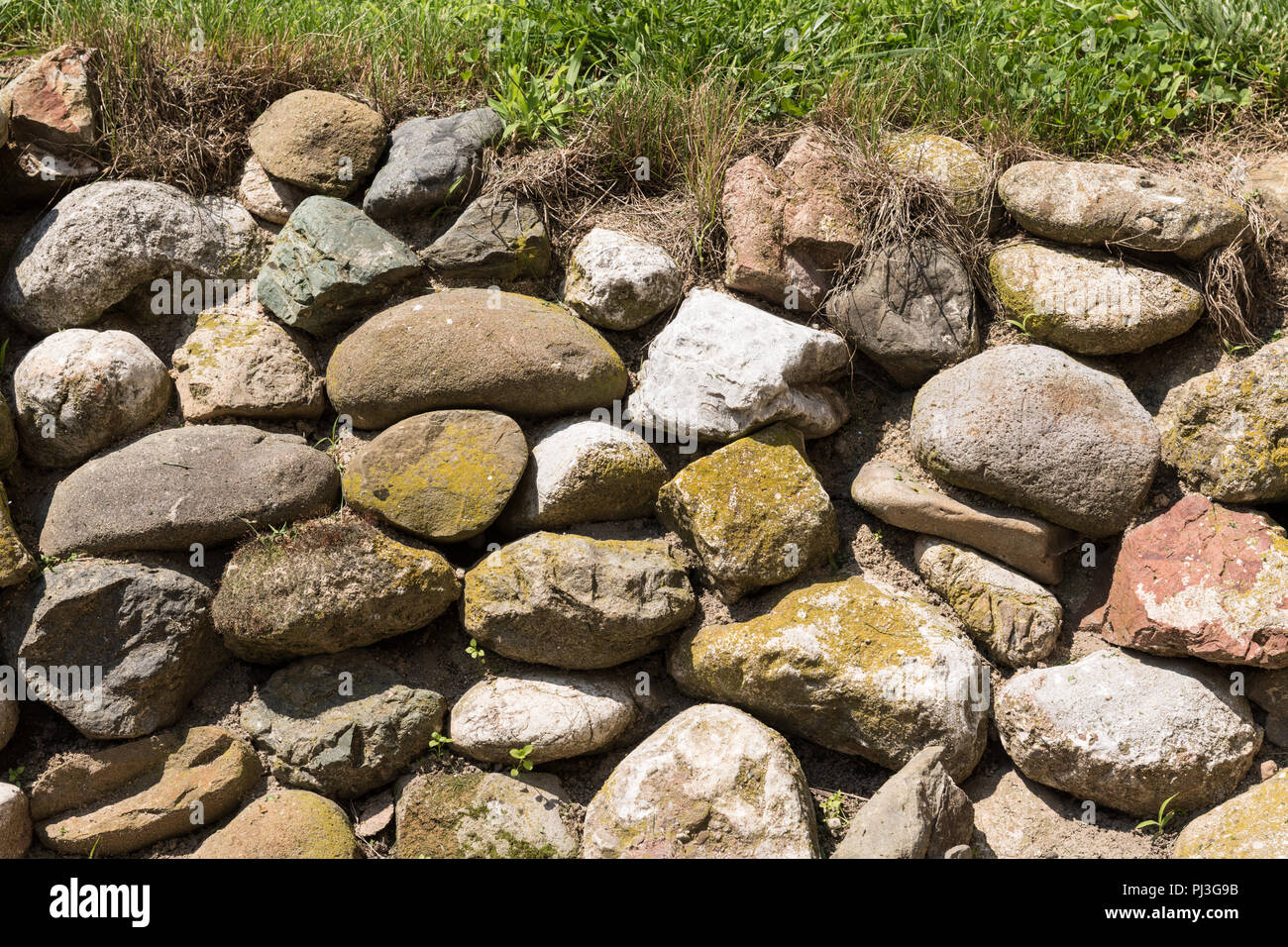 Old stone wall made with irregular blocks background texture with high ...
