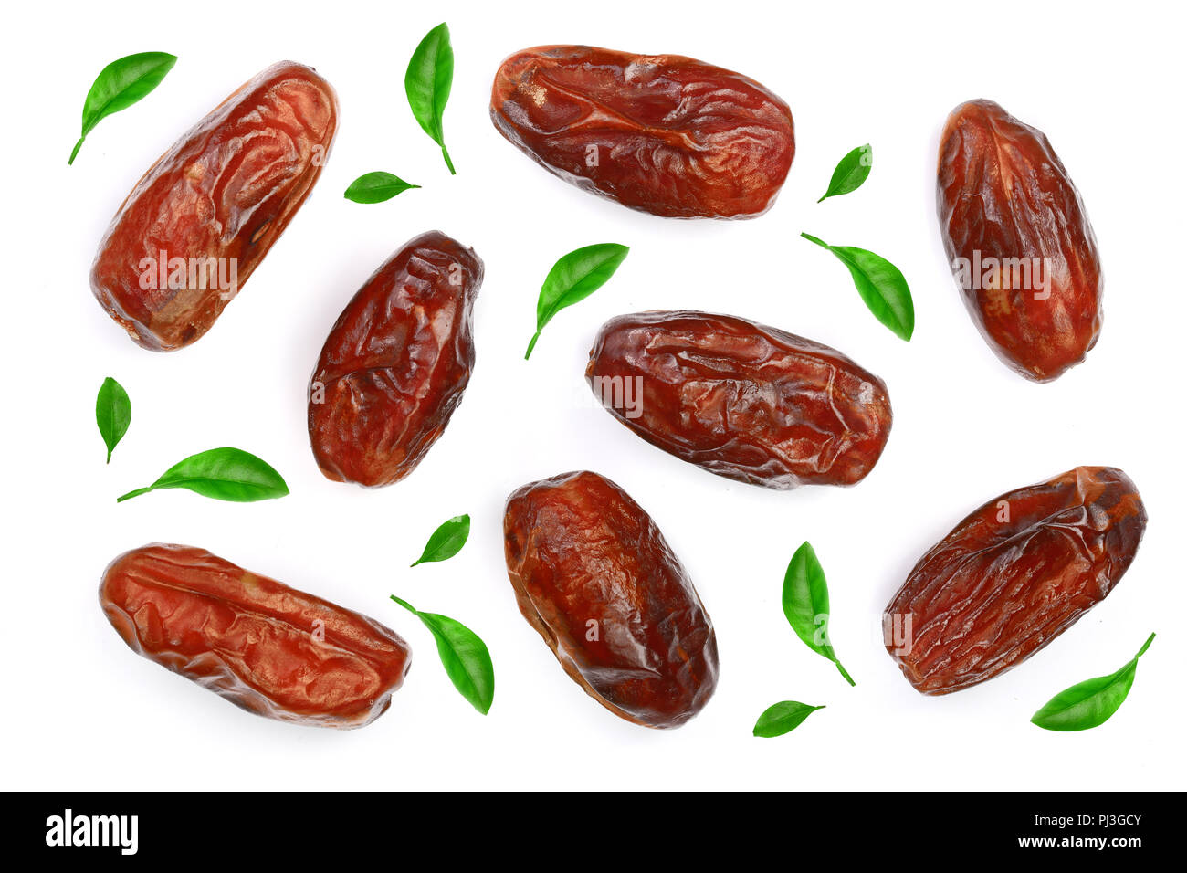 dry dates decorated with leaves isolated on white background. Top view ...