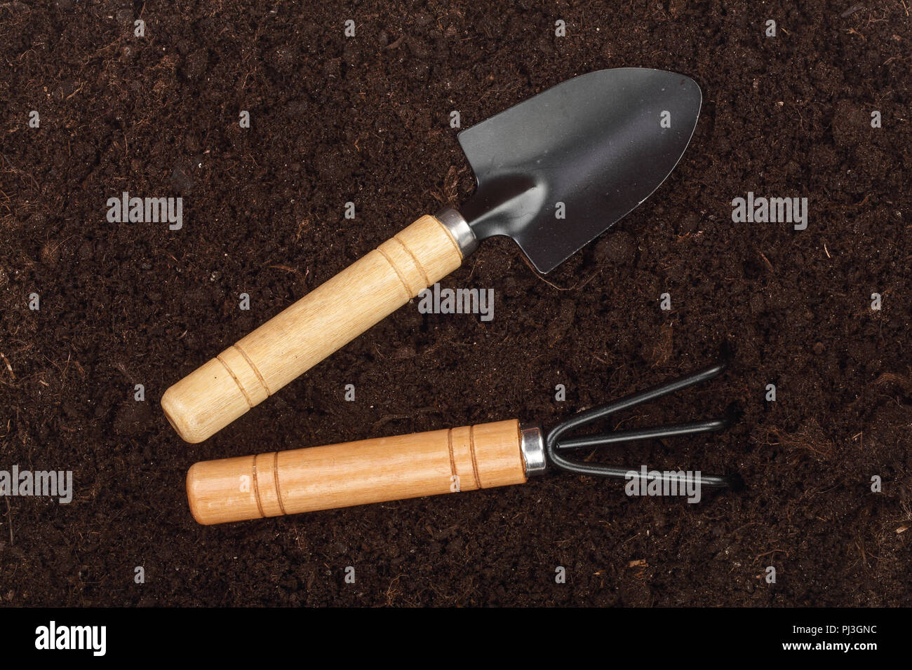 garden tools in soil as a background closeup Stock Photo - Alamy