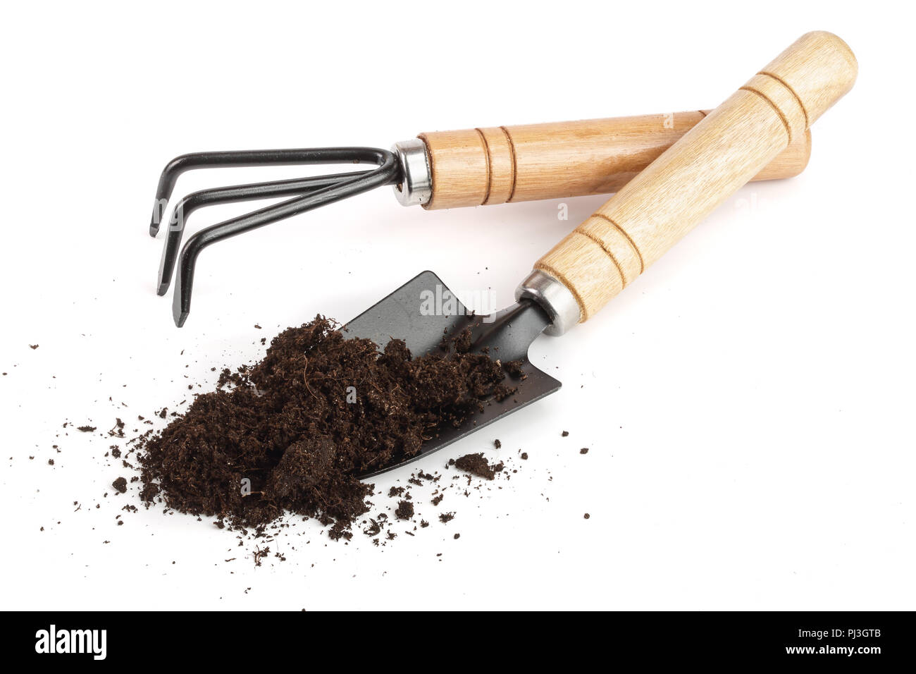 garden tools in soil isolated on white background Stock Photo - Alamy