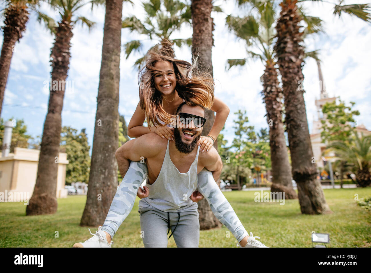 Happy Man Giving Girlfriend Piggyback Ride Park High Resolution Stock ...