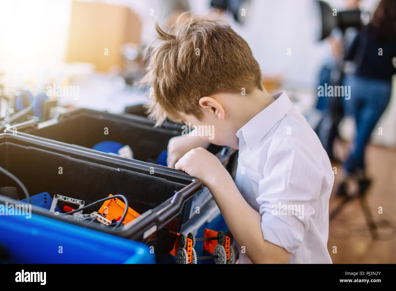 Little boy in robotics school makes robot Stock Photo - Alamy