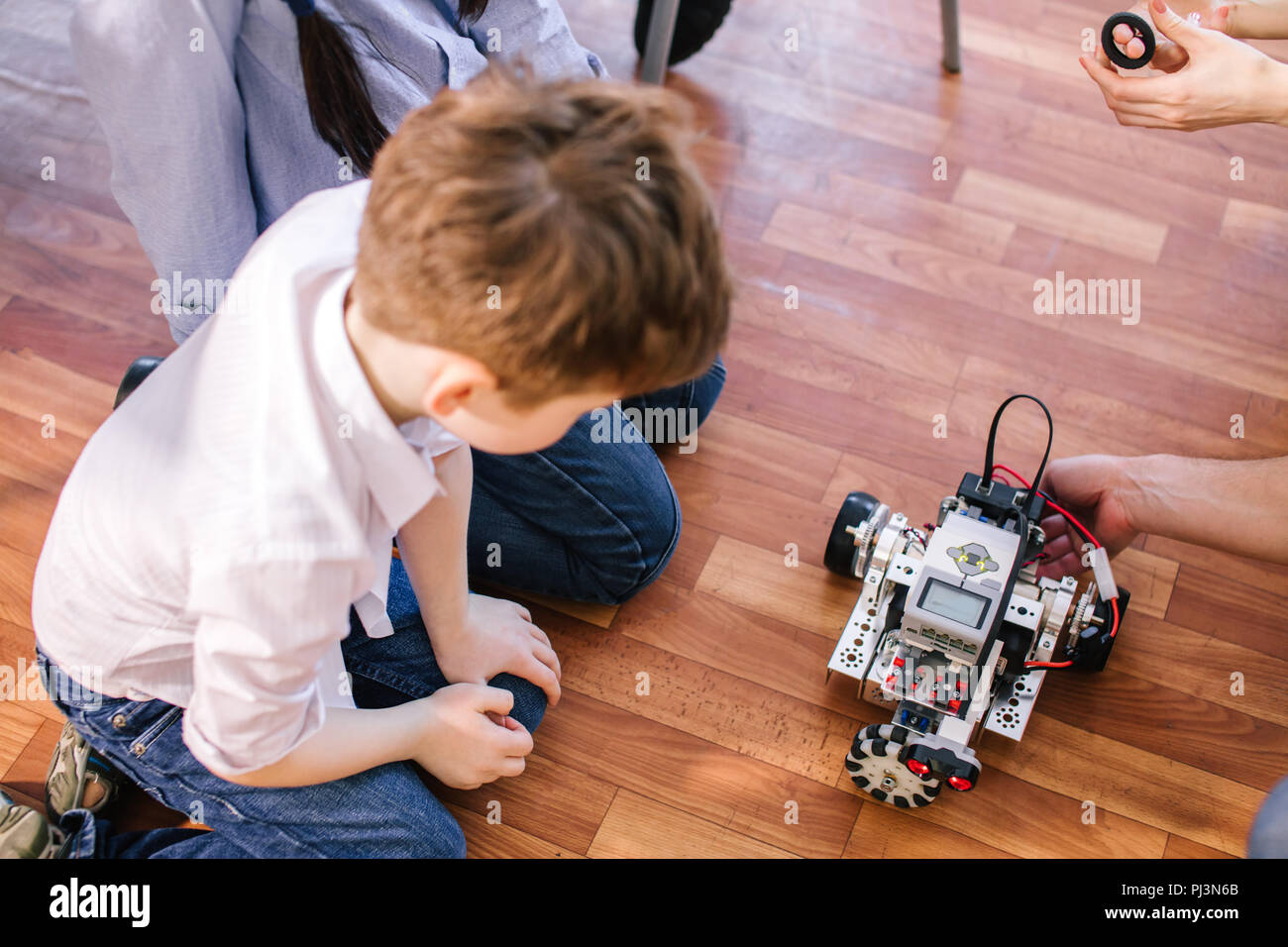 Little boy in robotics school makes robot Stock Photo - Alamy