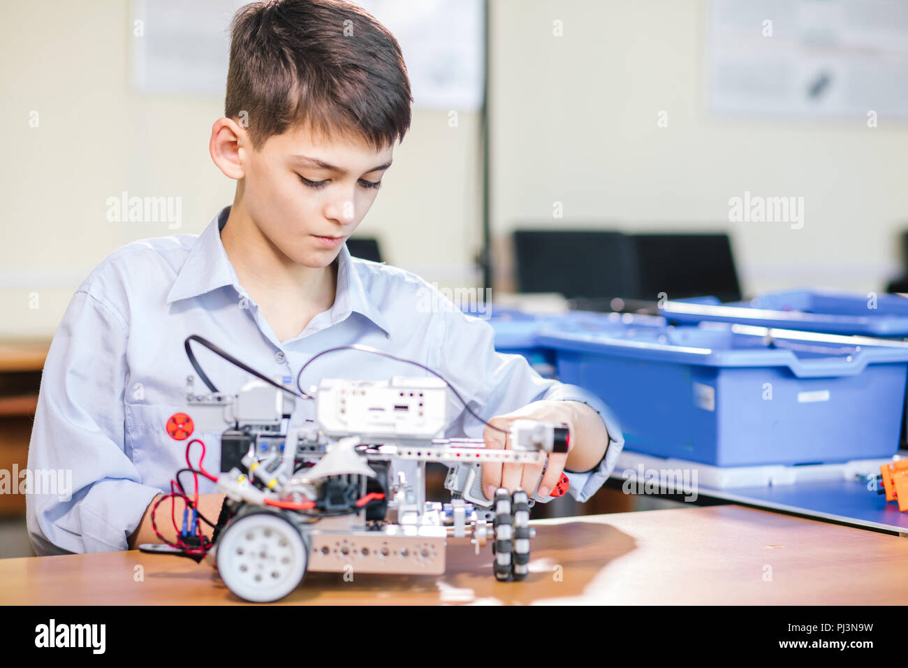 Little boy in robotics school makes robot Stock Photo - Alamy