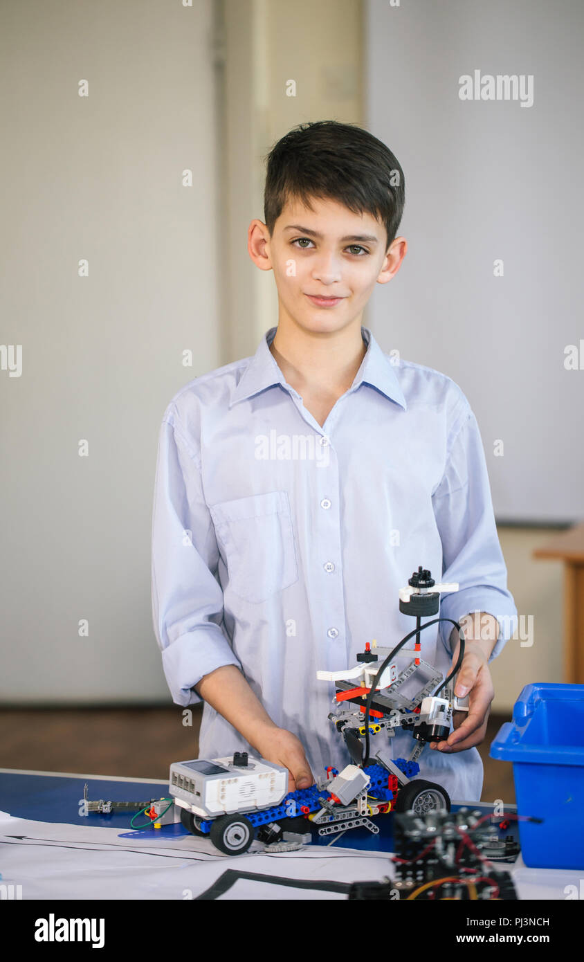 Little boy in robotics school makes robot Stock Photo - Alamy