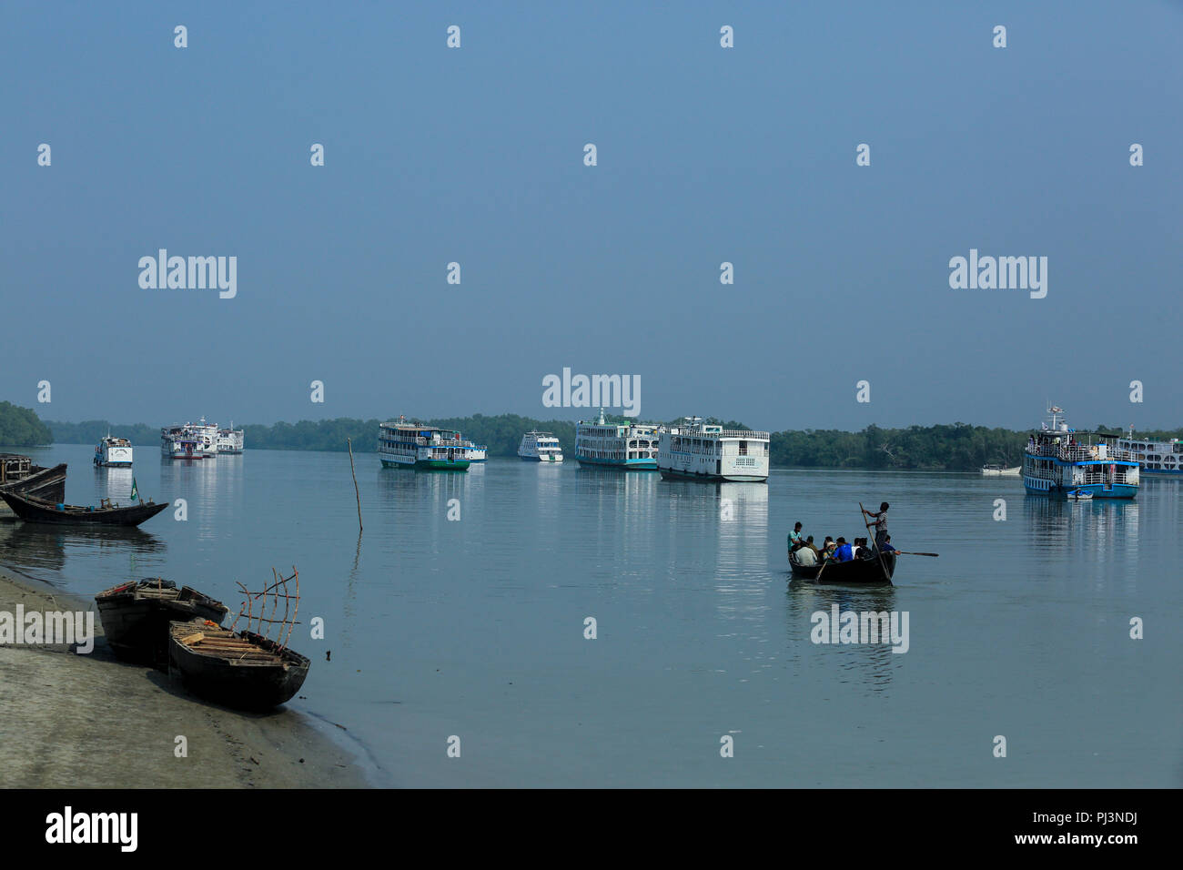 Tourist vessels anchored near the Kotka forest office in the Sundarbans ...