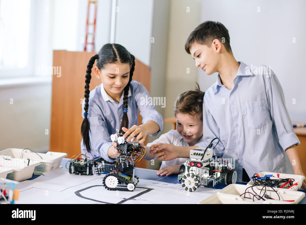 Two children, brother with sister enaging in their hobby-constructing ...
