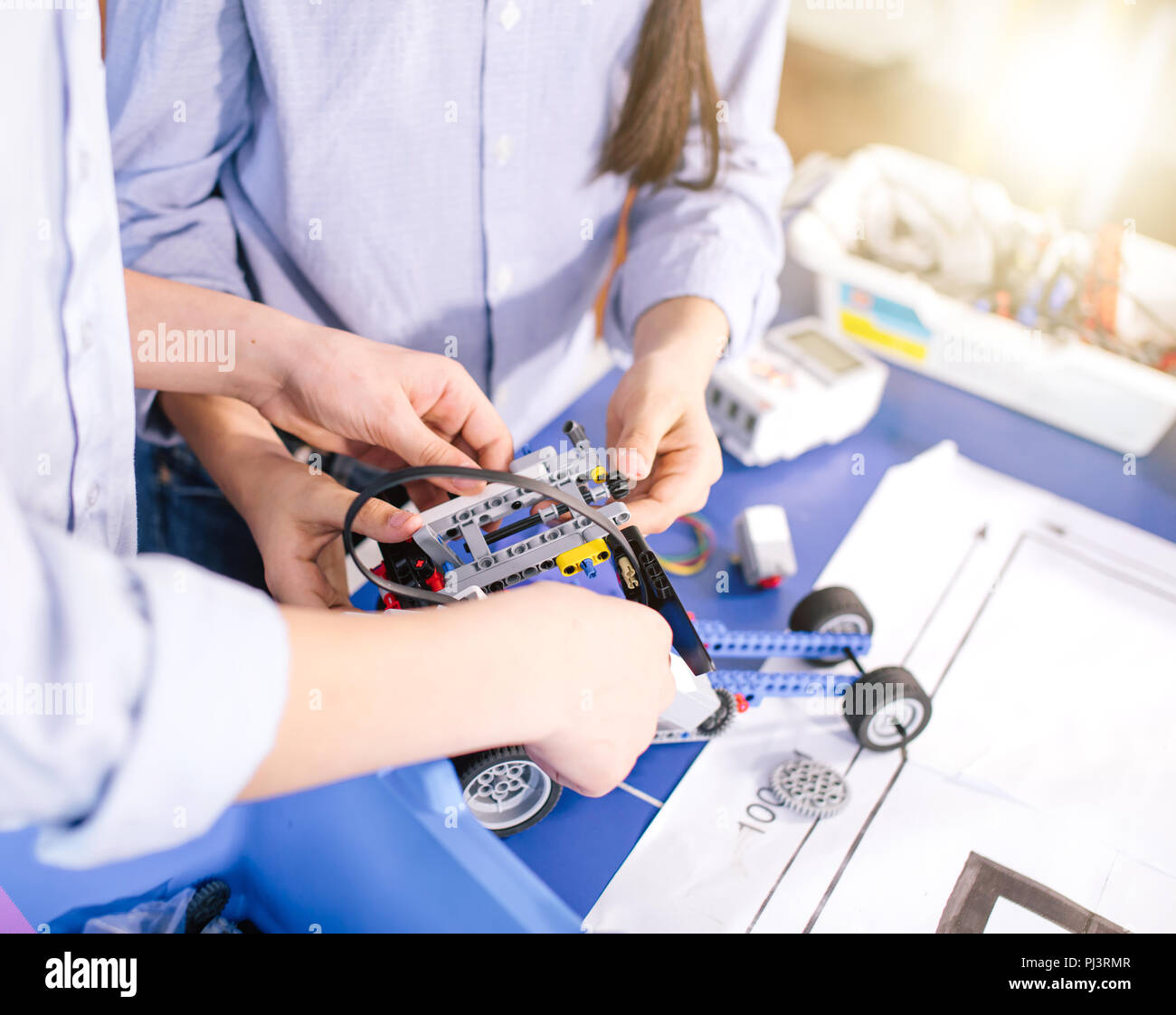 Busy technical team working on toy Stock Photo - Alamy