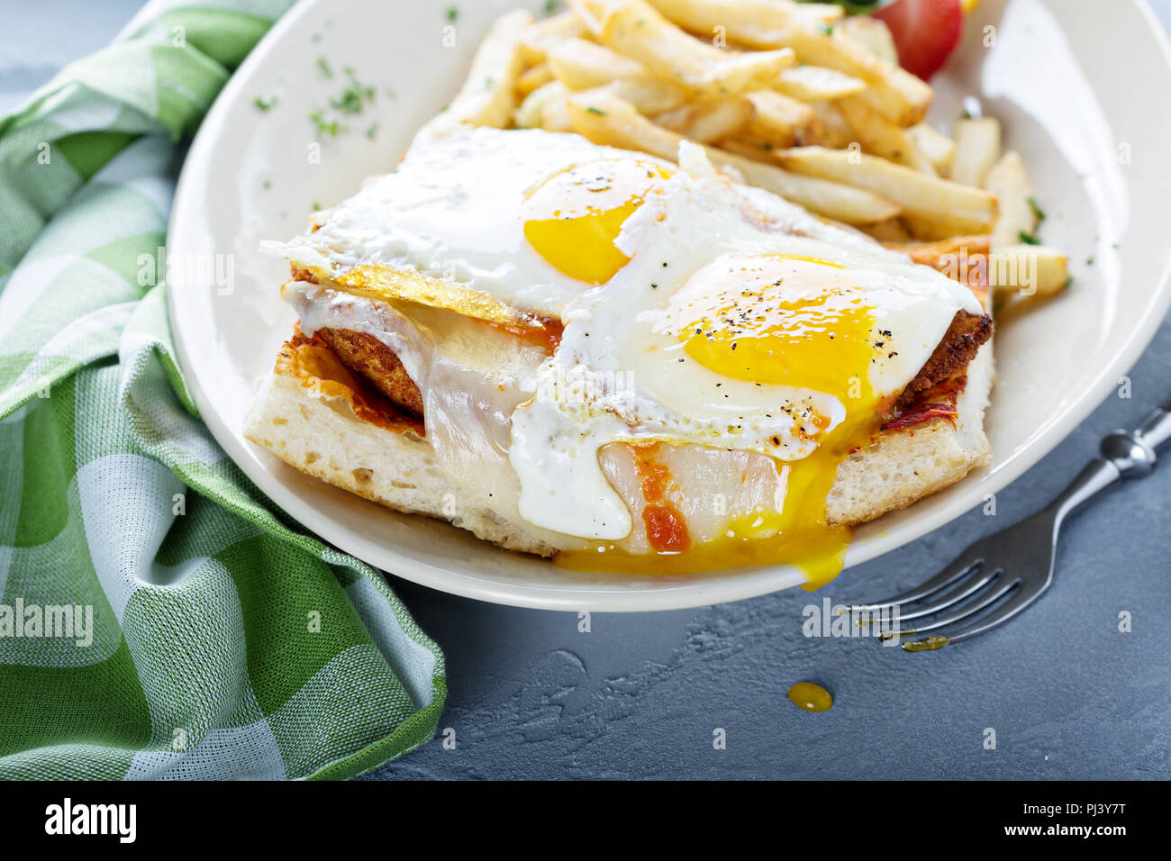 Sunny side up egg sandwich with fries for breakfast Stock Photo - Alamy