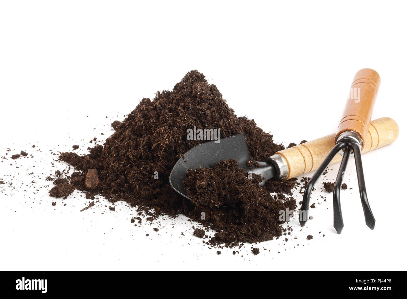 garden tools in soil isolated on white background Stock Photo - Alamy
