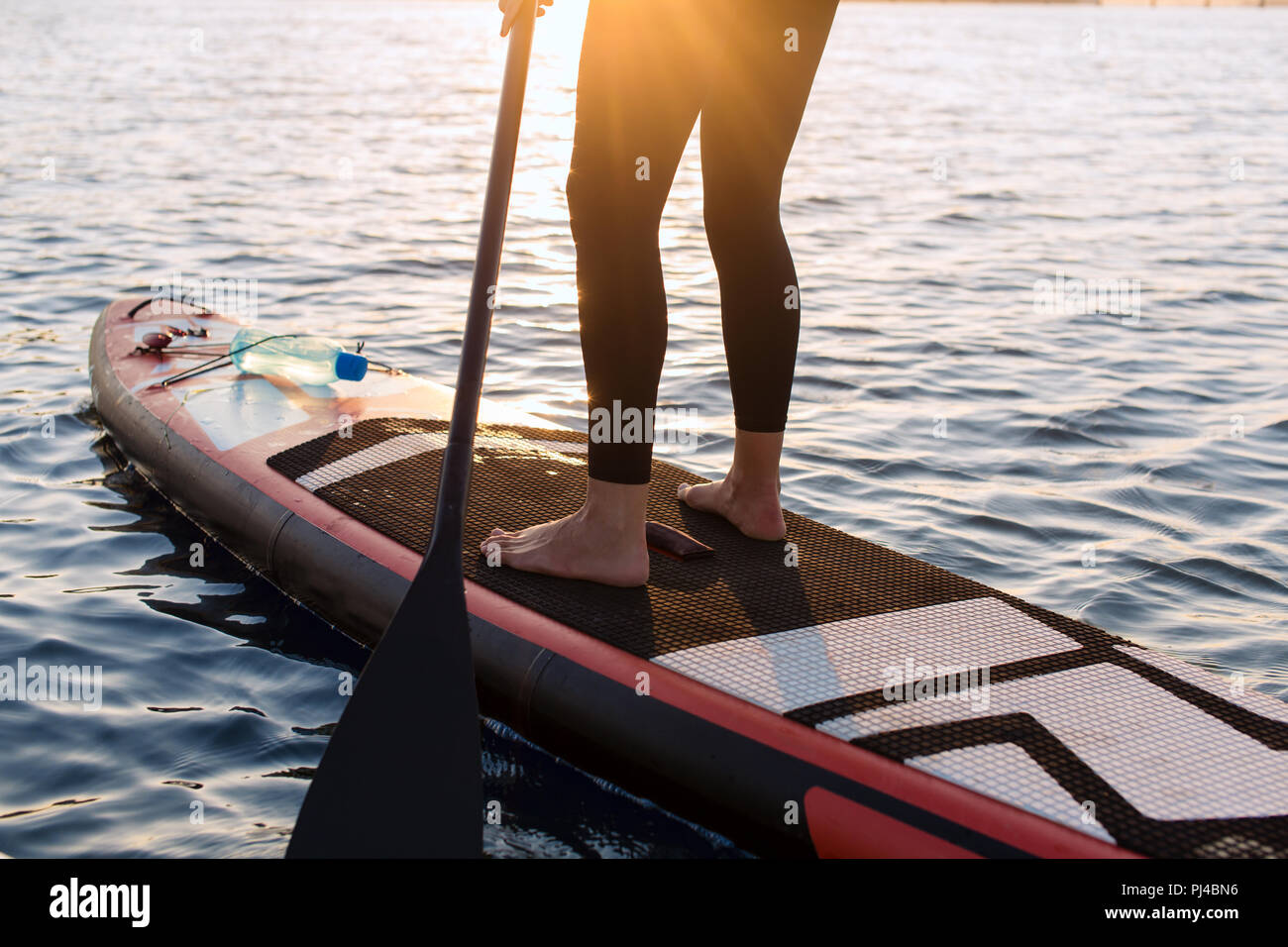 woman with a paddle on the blackboard. legs of a slender girl on stand ...
