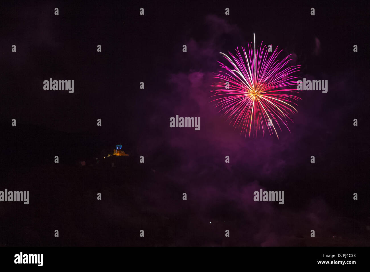 Violet fireworks with illuminated church of the patron saint of the ...