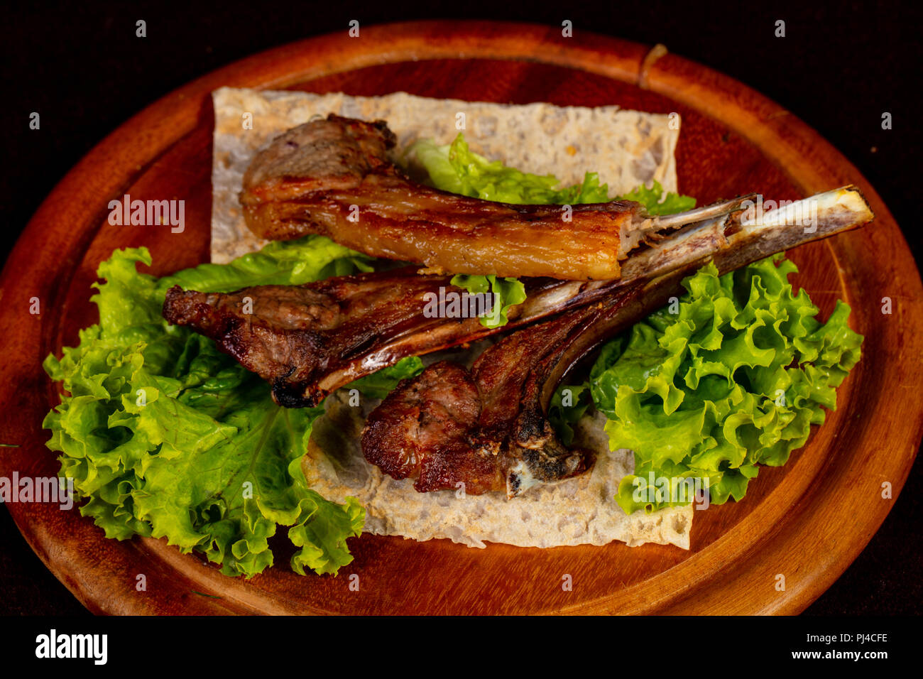 Grilled rack of lamb served salad leaves Stock Photo - Alamy