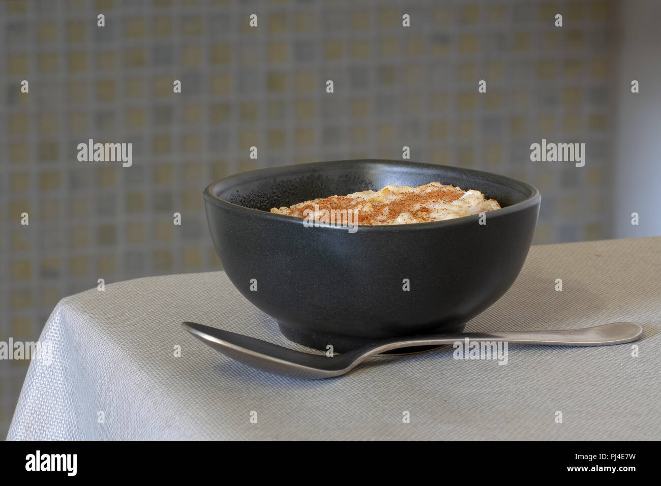 Just cooked authentic organic porridge in brown bowl on kitchen table ...