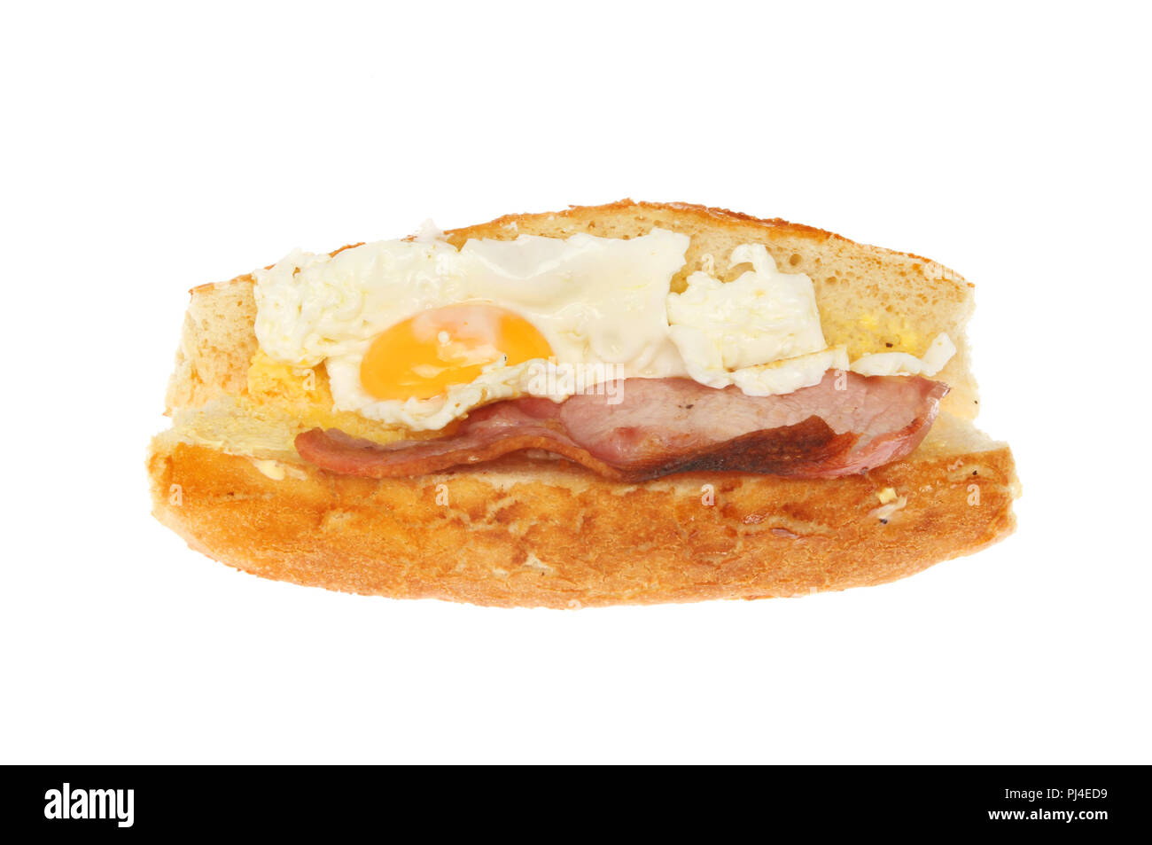 Fried egg and bacon in a crusty roll isolated against white Stock Photo ...
