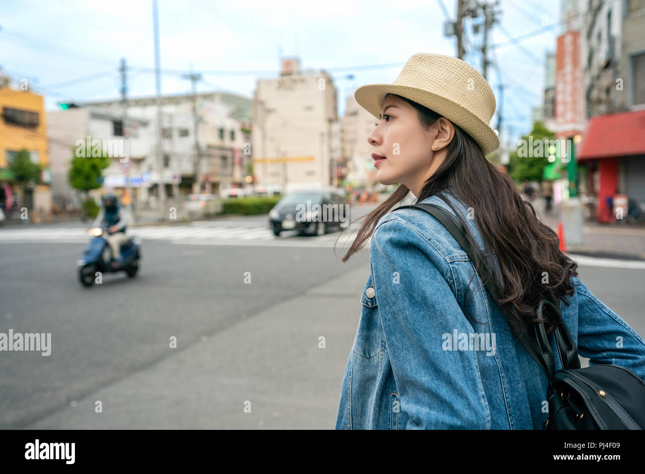 the back view of a pretty asian traveler looking at somewhere and ready ...