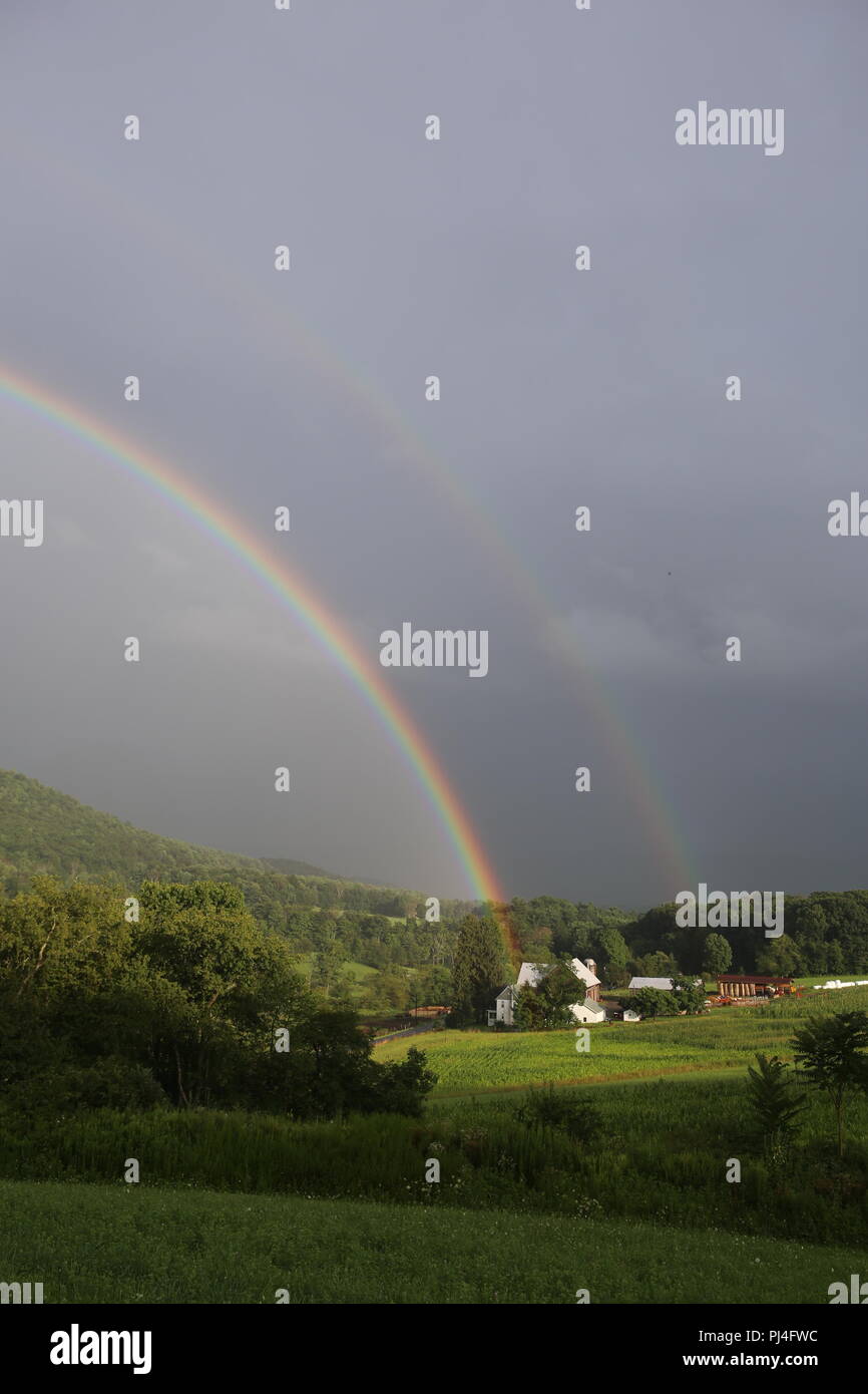 double rainbow over a farm mountain Stock Photo - Alamy