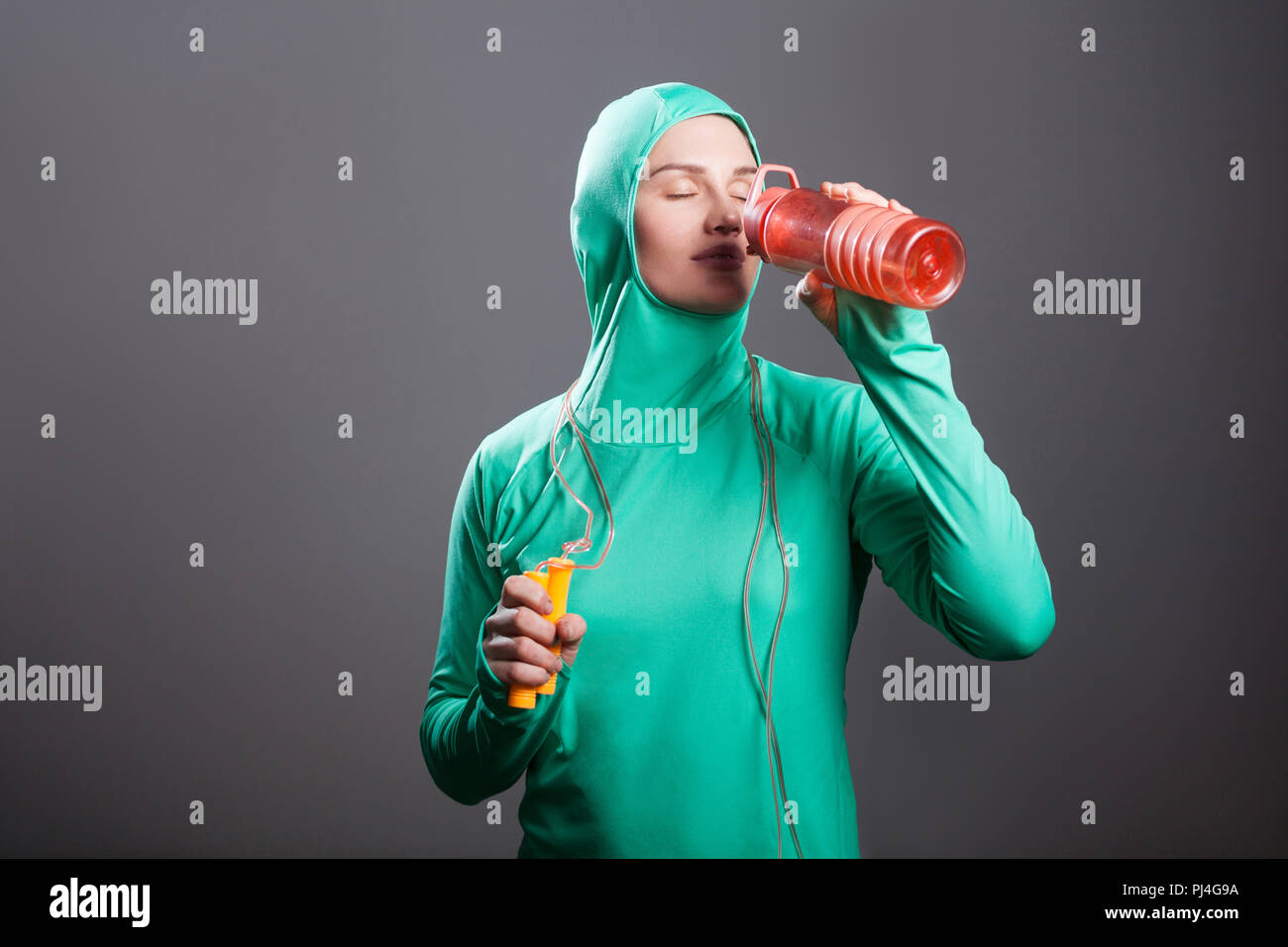 Beautiful relaxed athlete muslim woman in green hijab or islamic sport ...