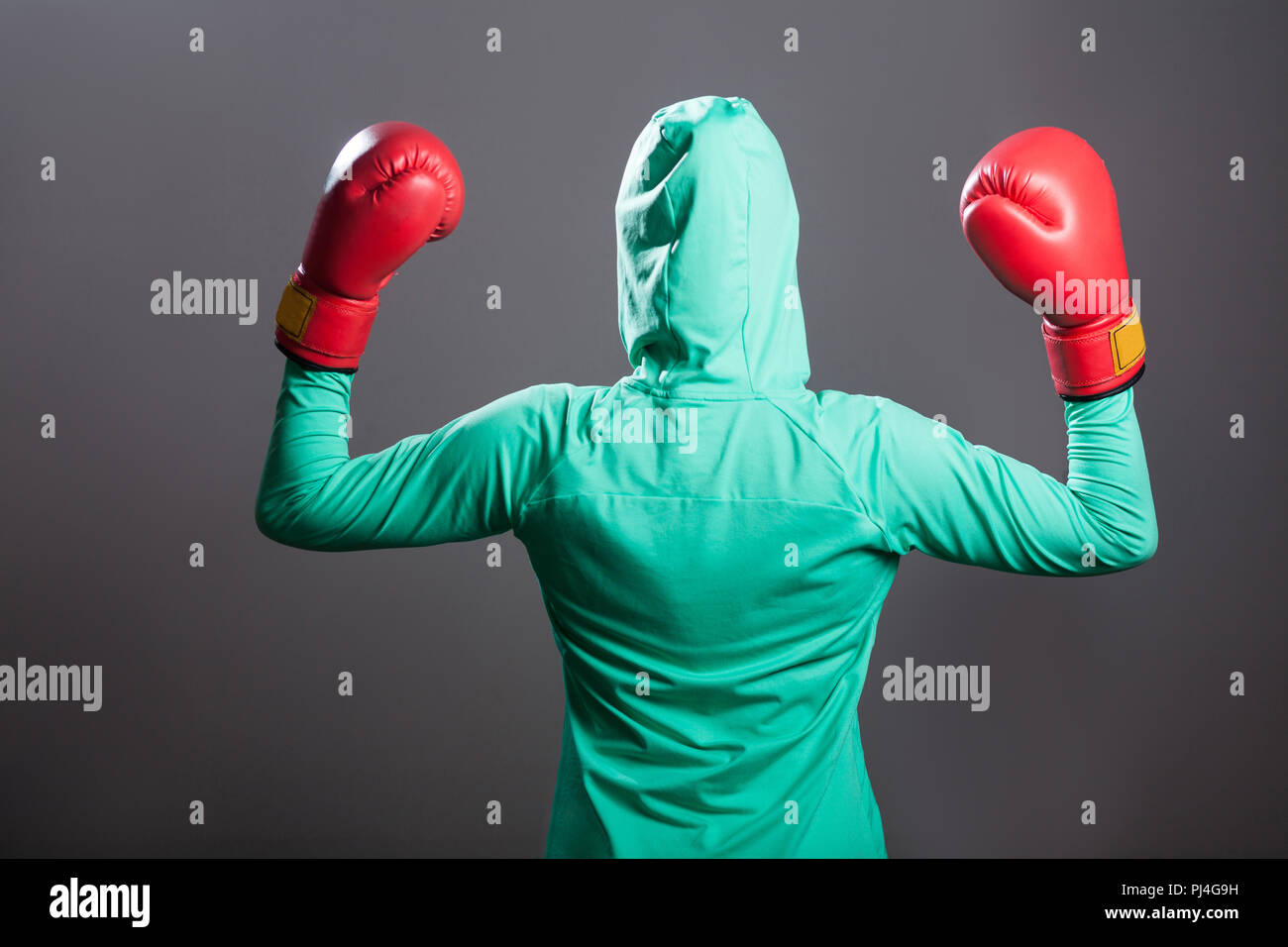Back side view of muslim boxer woman in green islamic sportswear ...