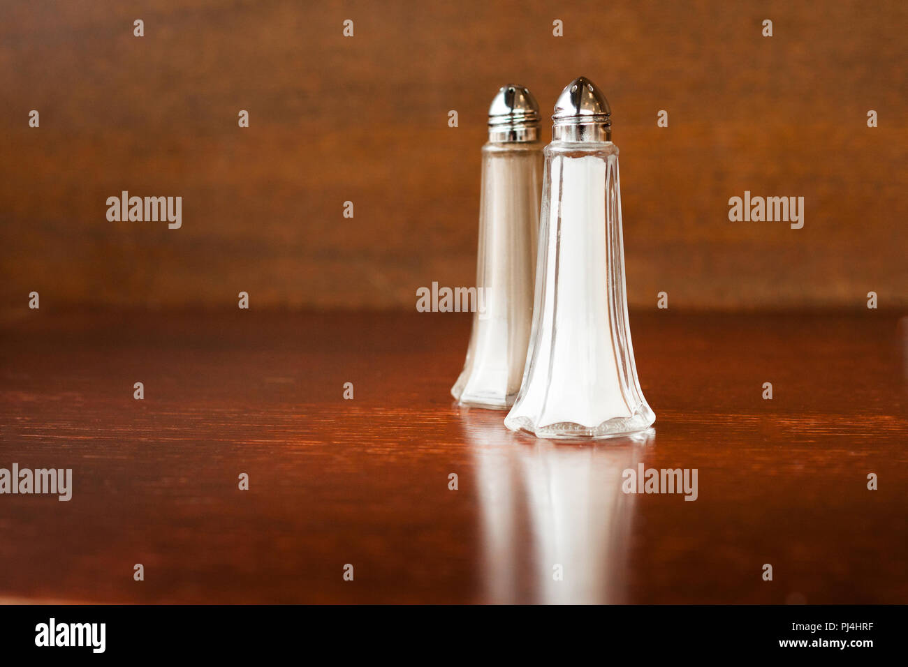 Pepper and salt shakers on restaurant table Stock Photo - Alamy