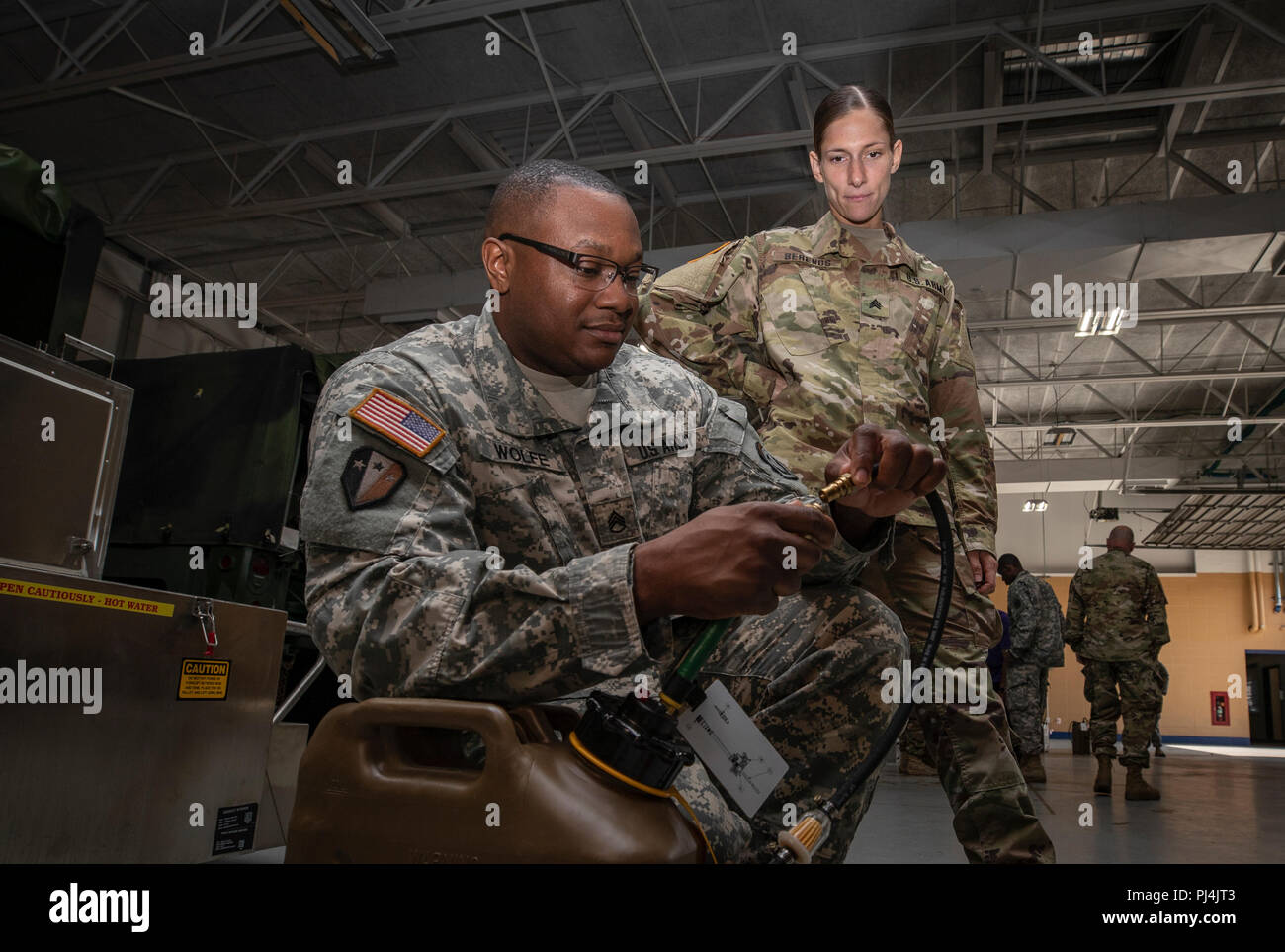 Staff Sgt. Kevin Wolfe, left, and Sgt. Elizabeth Berends, both food ...