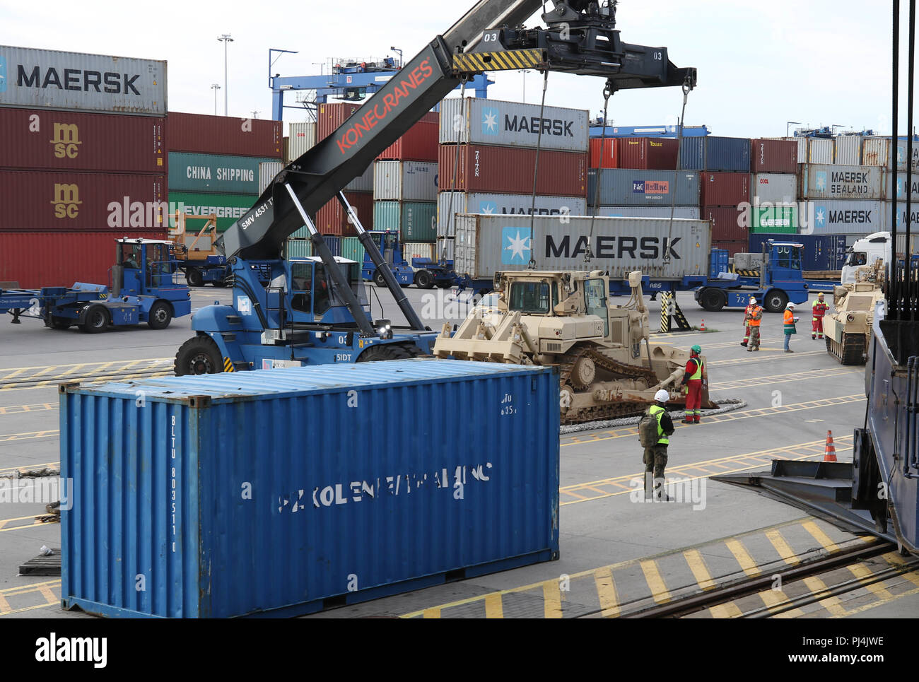 An employee with the Deepwater Container Terminal prepares a crane to ...